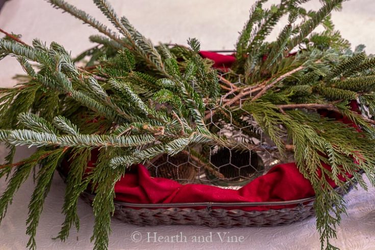 Christmas Table Centerpiece Made with Evergreens and Ornaments